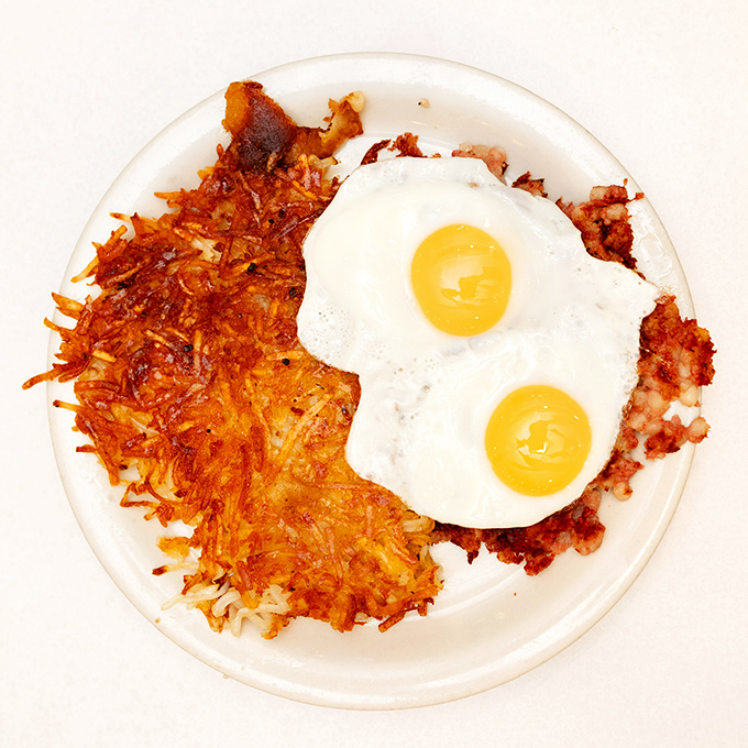Crispy hash browns and sunny-side-up eggs—the breakfast equivalent of a perfect sunrise, where every bite delivers that satisfying crunch-to-gooey ratio.