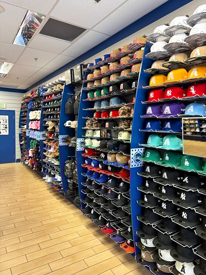 Baseball cap nirvana stretches as far as the eye can see, with team loyalties organized in chromatic harmony that would make Marie Kondo weep with joy.