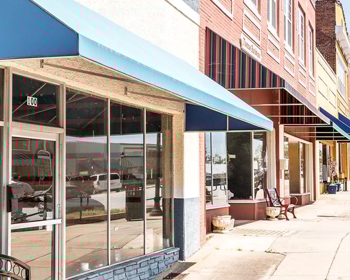 Empty storefronts with endless potential wait for their next chapter, windows reflecting both past glory and future possibilities.