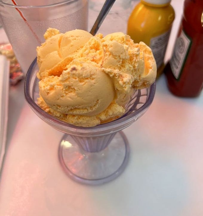 Orange sherbet that looks like sunshine in a glass—the kind of simple pleasure that makes adults remember what summer tasted like as kids.