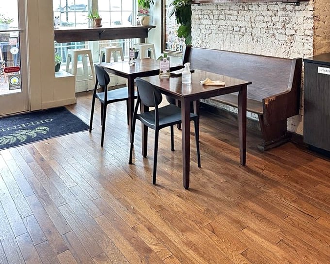 Clean lines, warm wood, and white brick create a dining space that's somehow both minimalist and welcoming—the Meryl Streep of cafe interiors.