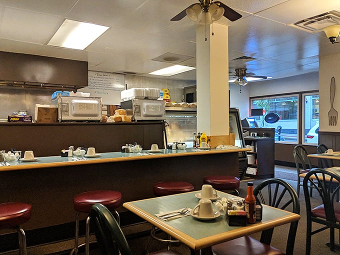 The counter seating and open kitchen layout – where breakfast theater happens daily and regulars have their unofficial assigned seats.