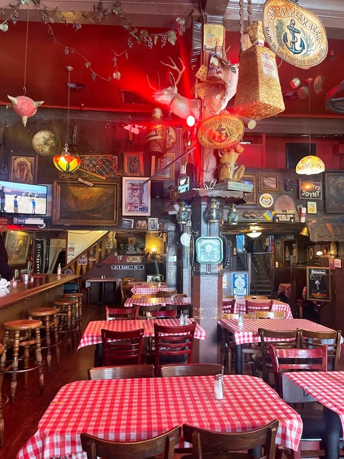 The dining room feels like your eccentric uncle's basement—if your uncle collected vintage signs, mounted deer heads, and had an uncanny knack for creating cozy chaos.