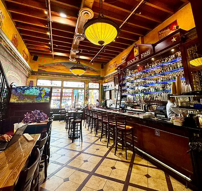 The bar area glows with amber lighting and promises of good times. Those pendant lights aren't just illuminating the room—they're setting the mood.