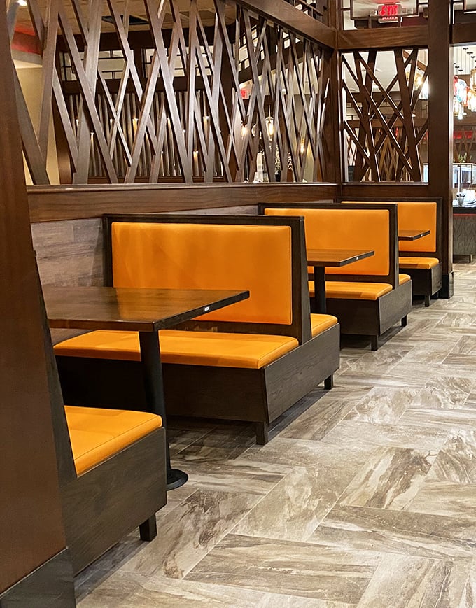 These orange booths aren't just seating—they're your front-row tickets to the greatest show on earth: unlimited food.