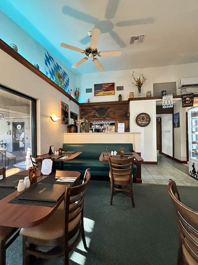 The dining room's blue ceiling glow creates an atmosphere somewhere between Bavarian beer hall and cozy Alpine retreat. No lederhosen required.