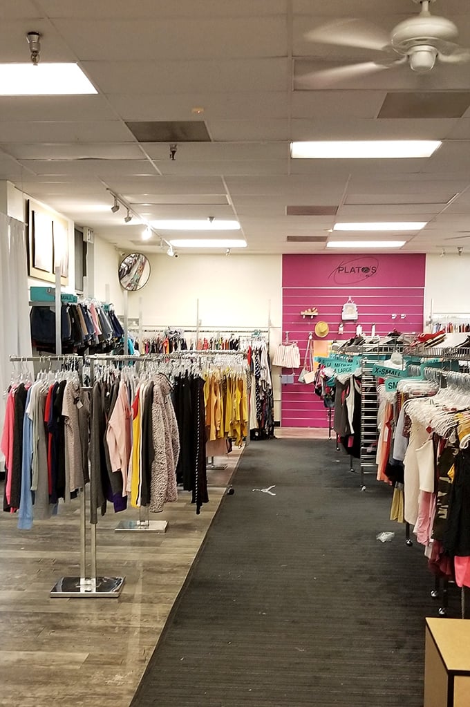 The dream thrift aisle does exist—rows of neatly sorted styles, color pops galore, and a pink wall up front that feels like fashion calling your name.