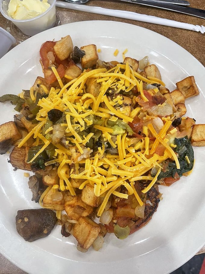 These aren't just loaded potatoes—they're a carefully constructed landscape of flavors where cheese, veggies, and crispy spuds live in perfect harmony.