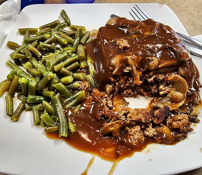 Meatloaf that doesn't just remind you of home – it makes you question why you ever left. Those green beans aren't an afterthought; they're the supporting actor who steals the scene.
