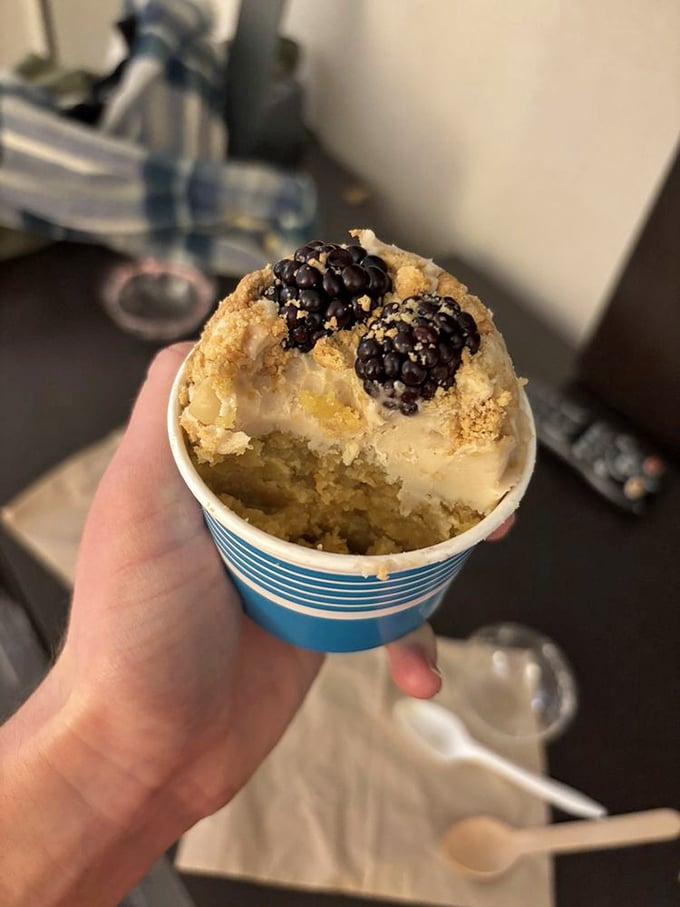 Cake in a cup with blackberries: proof that portion control can still be wildly exciting. The partially eaten section reveals the treasure within.