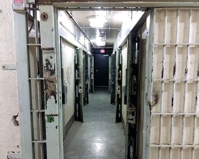 The institutional yellow paint can't brighten the sobering reality of this cellblock hallway where inmates once peered out through bars, counting days until release.