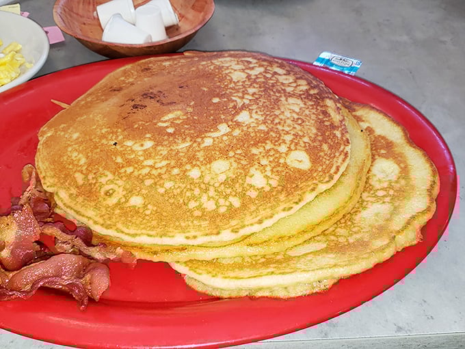 Golden pancakes stacked high with a side of bacon—the breakfast that says, "Today might be tough, but at least it started right."