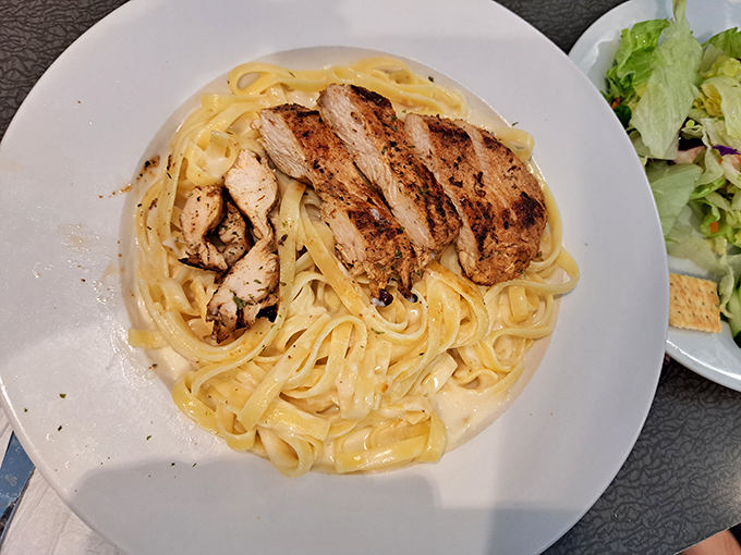Fettuccine Alfredo with grilled chicken—where comfort food gets dressed up for a night out but still remembers its humble, delicious roots.