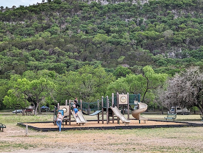 The playground where kids burn off energy while parents secretly calculate how many more hours until they can justifiably have a beer.