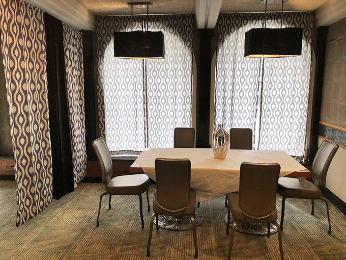 The private dining area offers a touch of mid-century modern elegance with patterned curtains and clean lines – perfect for family celebrations or clandestine business deals.