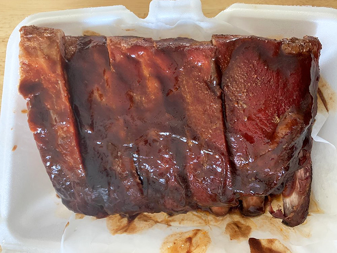 Ribs with that perfect mahogany sheen—the barbecue equivalent of a sunset. That glistening sauce tells you everything you need to know about the flavor journey ahead.