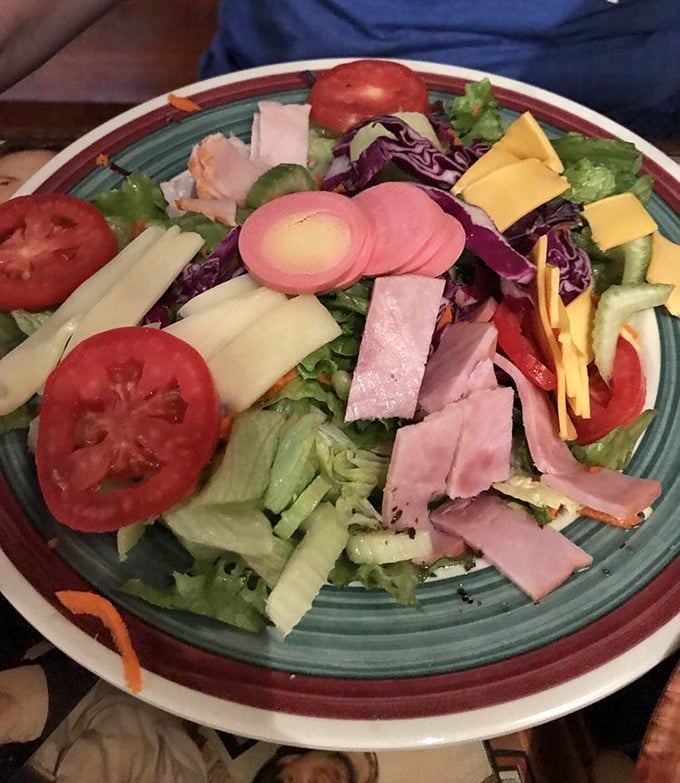 A chef salad that defies the "sad salad" stereotype – this colorful arrangement of ham, cheese, and fresh vegetables proves healthy can be hearty.