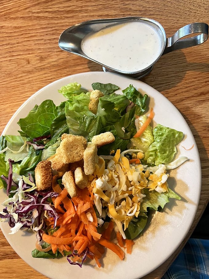 Even the salad gets respect here—fresh, colorful, and substantial enough to satisfy without filling the space reserved for the main event.