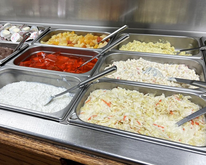 A salad bar that doesn't apologize for its simplicity – fresh ingredients arranged without pretense, waiting for your personal touch.