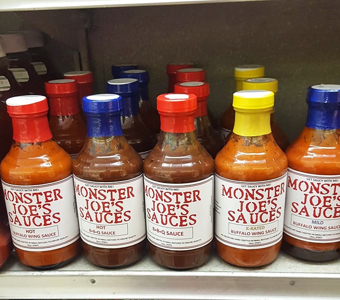 Monster Joe's sauces stand at attention like colorful soldiers ready to elevate your sandwich experience. Choose your weapon wisely.