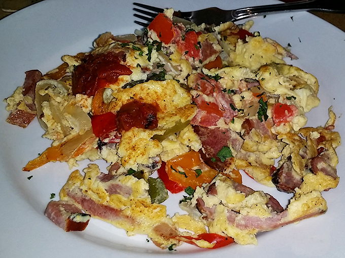 A scramble that refuses to be ordinary. Colorful vegetables and herbs transform humble eggs into a morning masterpiece worth waking up for.
