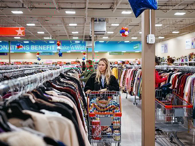 A savvy shopper navigates the aisles with purpose, her cart already telling tales of victories won and deals discovered.