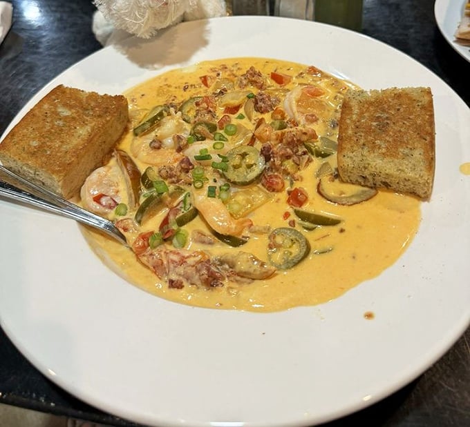 A creamy bowl of shrimp and grits that would make a Lowcountry grandmother nod in approval. Those zucchini slices aren't just garnish—they're part of the conversation.