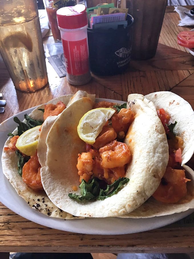 Soft tacos cradling plump shrimp and fresh greens—portable pockets of seafood joy that make utensils seem entirely optional.