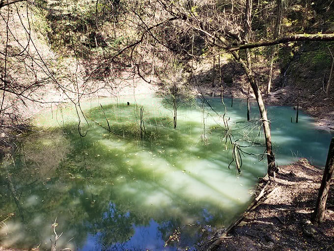 The emerald pool at the bottom of the sinkhole glows with an otherworldly light. No, it's not radioactive—just a stunning natural phenomenon.