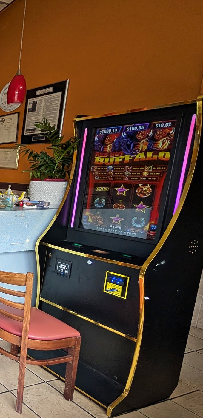 Between bites of curry, some patrons try their luck at the gaming machine – though the real jackpot is already on your plate.