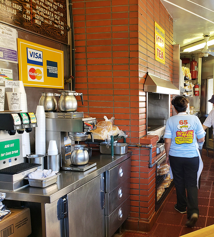 Behind every great pastrami is a dedicated team—the kitchen staff moves with the choreographed precision of sandwich ballet performers.