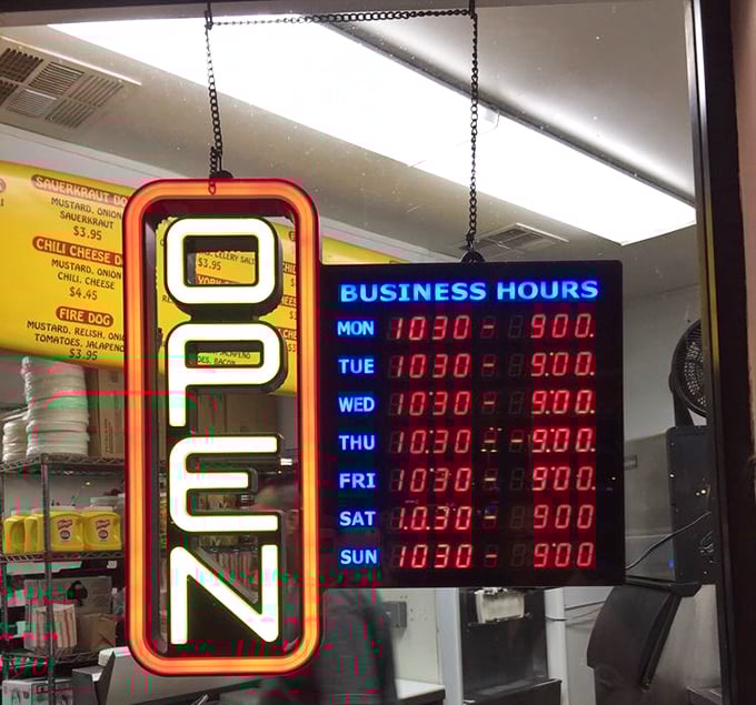 The neon "OPEN" sign—a modern-day North Star guiding hungry pilgrims to hot dog nirvana. Those hours are worth memorizing.