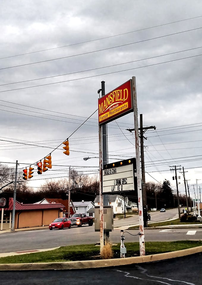 The roadside sign stands like a beacon of hope for hungry travelers - "Yes, we're still here, and yes, we still know how to cook."