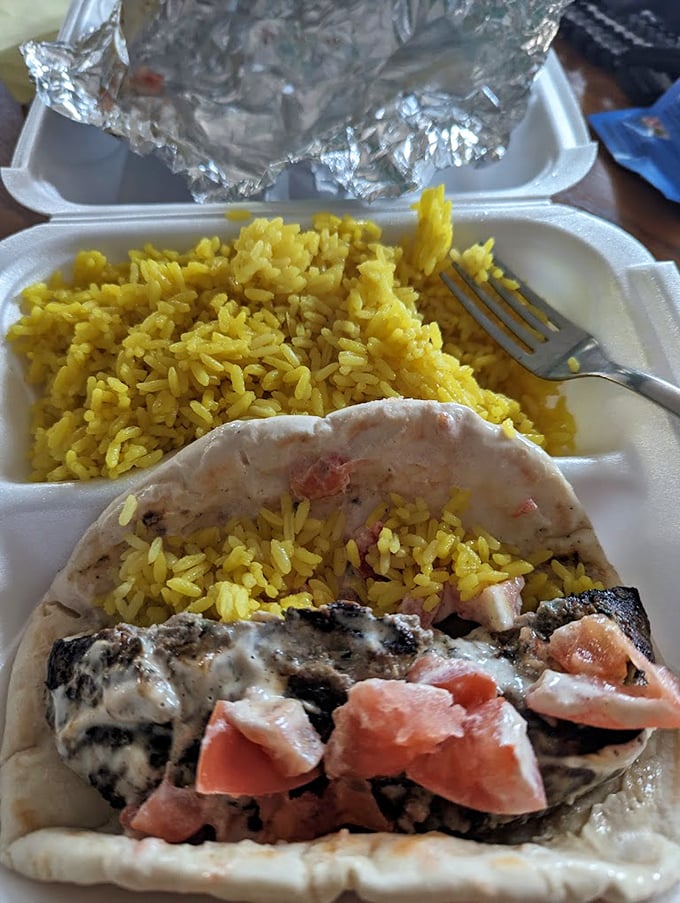 The gyro in its takeout glory—proof that some of life's greatest pleasures don't require fancy china or cloth napkins to be magnificent.
