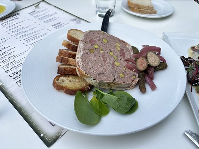 The terrine—a mosaic of meat that's essentially pâté's more sophisticated cousin—arrives with perfectly toasted bread and house-made pickles.