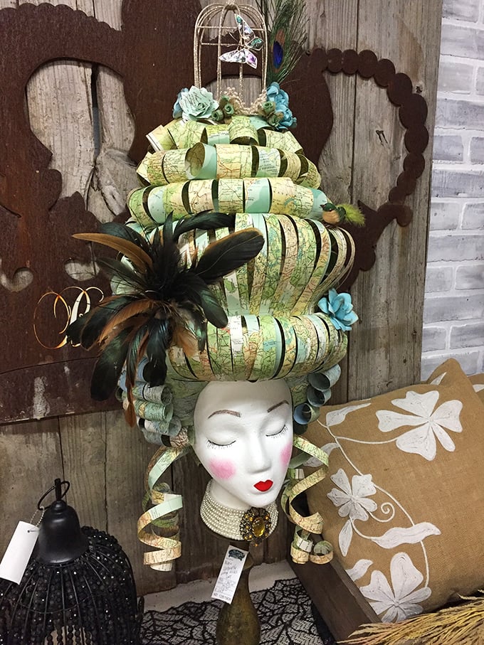 Not your average mannequin head – this theatrical creation with map-inspired styling would make any conversation piece jealous.