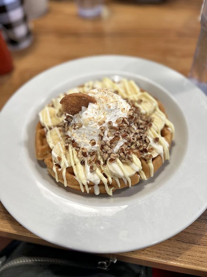 A waffle that's dressed for success with cream, pecans, and what appears to be a drizzle of pure joy. Breakfast or dessert? Why choose?