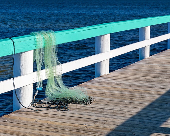 A fishing net draped casually over the railing tells the story of Pine Island – where catching dinner isn't just recreation, it's tradition.