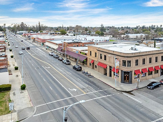 Tree-lined streets create natural canopies in Chowchilla, shading both sidewalks and sensible housing costs below.