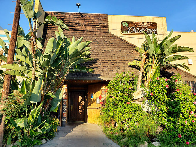 Tropical plants and weathered shingles hint at the unique island-meets-steakhouse experience awaiting inside.