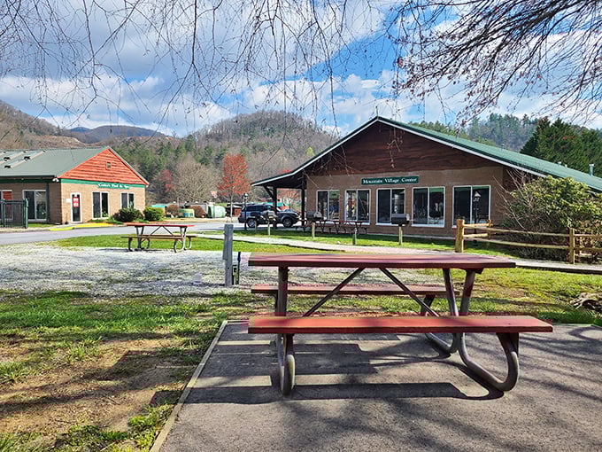 Mountain village center with picnic tables waiting for visitors – small-town charm that big cities try desperately to recreate.