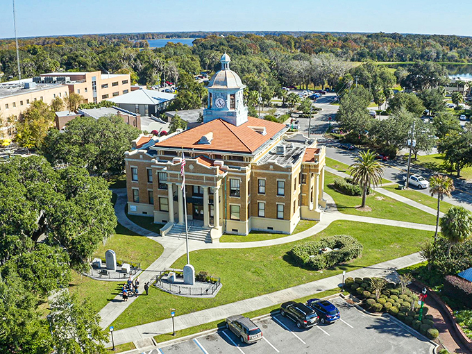 Inverness courthouse stands proudly among ancient oaks, representing small-town governance with architectural dignity and Southern charm.