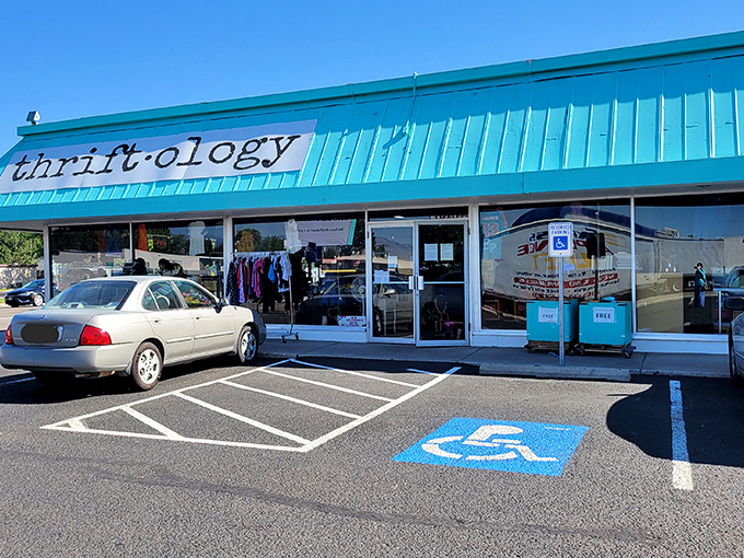 Thriftology's turquoise awning pops against the pavement—a boutique approach to secondhand shopping in Garden City.
