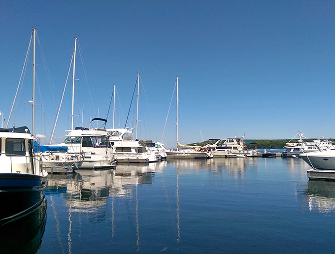 Boats bob gently in Fish Creek's harbor while visitors stroll the marina, ice cream cones in hand, soaking up pure Door County bliss.
