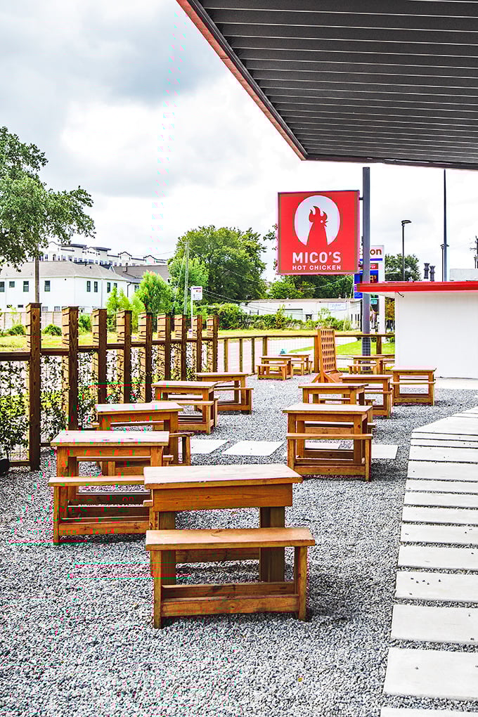 Mico's outdoor seating: Those wooden benches aren't just for sitting—they're front-row seats to Houston's most exciting chicken show.