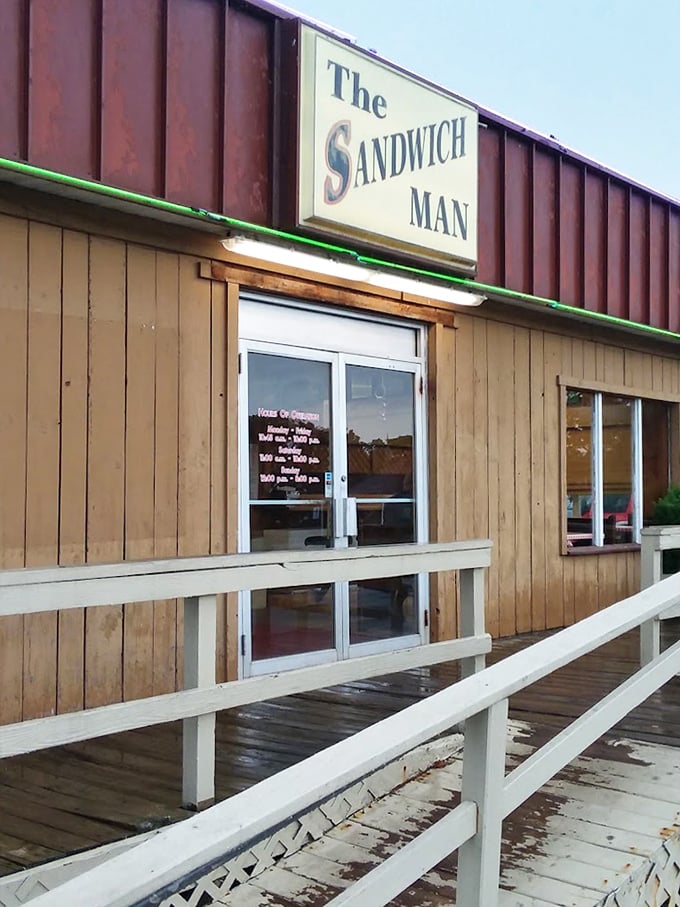 That wooden deck whispers "come sit a spell" while promising sandwiches worth the leisurely visit.