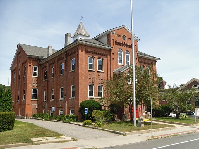 This stately brick masterpiece in Winsted stands like Winchester's own mini-Capitol – governing a town where Social Security checks actually cover living expenses.