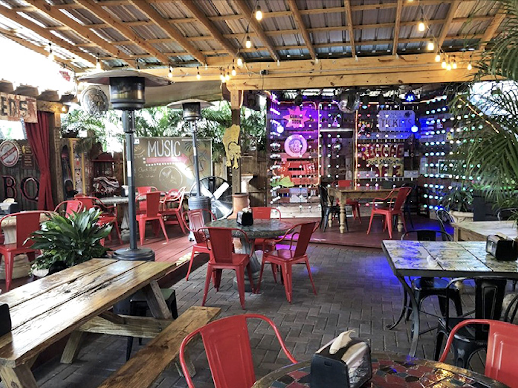The outdoor seating area strikes that perfect Florida balance—just enough cover to escape the sun, just enough openness to enjoy the breeze.