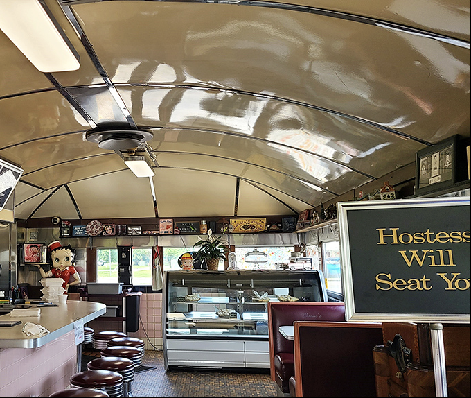 Step inside and the curved ceiling, vintage counter, and "Hostess Will Seat You" sign transport you to a simpler time when conversations happened face-to-face.