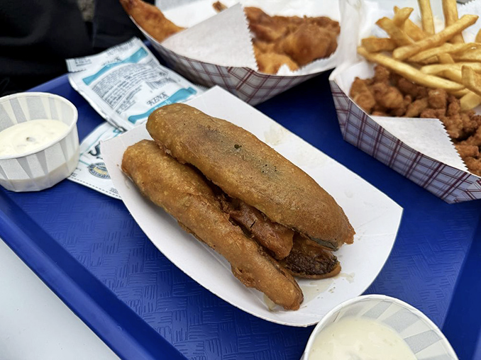 These golden-battered treasures might look like corn dogs, but they're actually fried pickles—crunchy, tangy surprises that vanish faster than you can say "dill-icious."